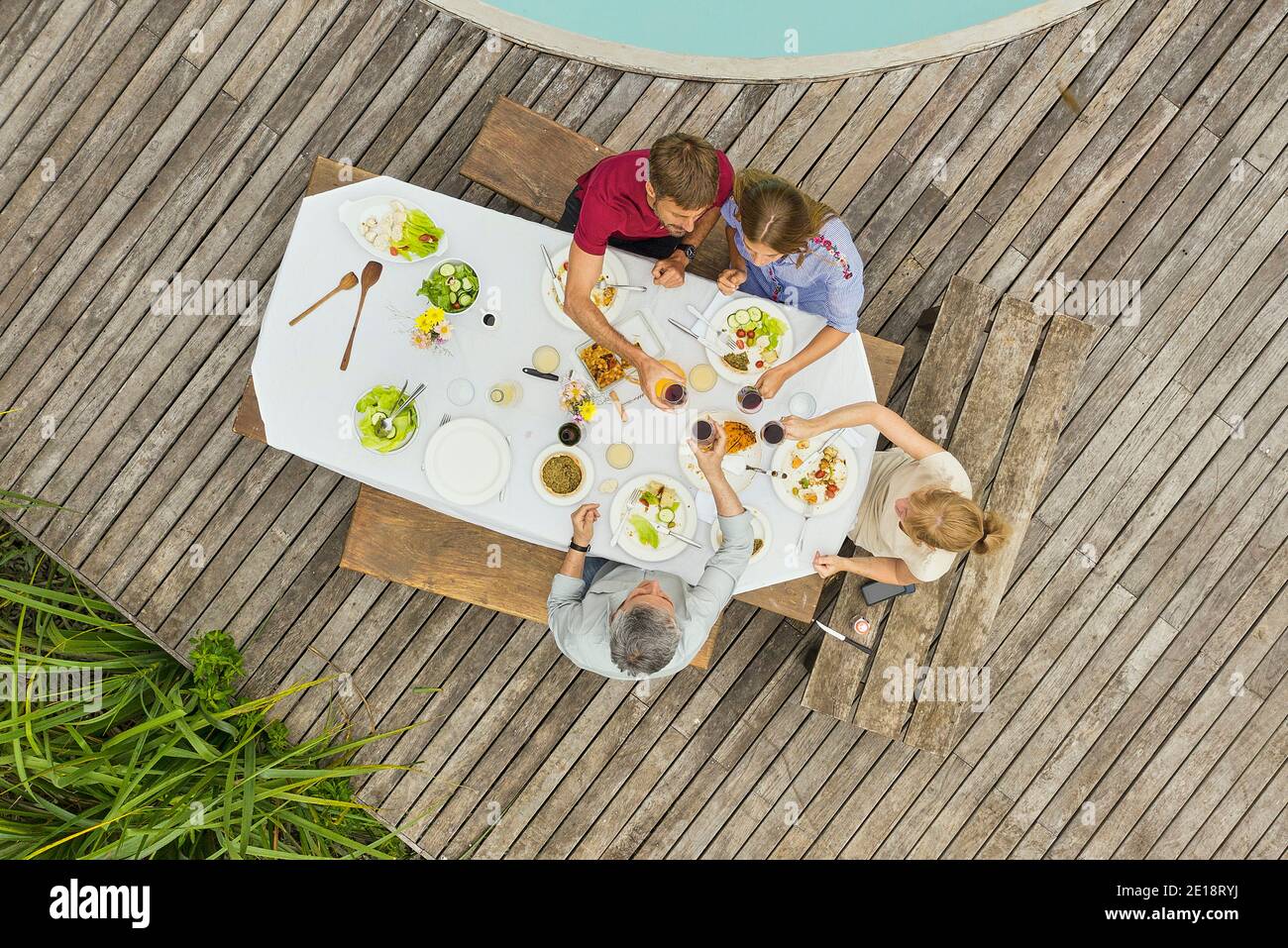 Family having lunch at poolside Stock Photo - Alamy