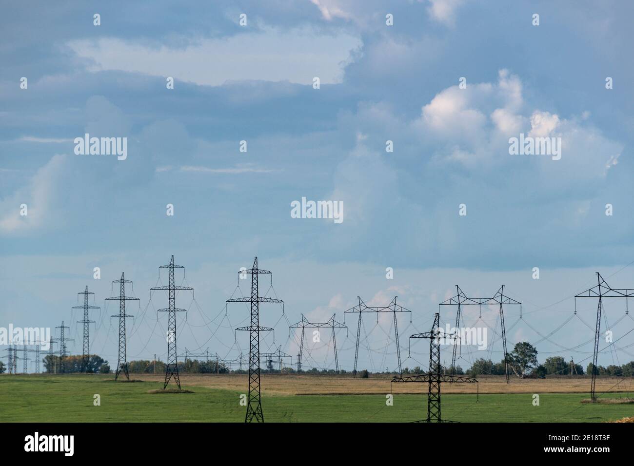Farm field with power lines on horizon. Energy transportation Stock ...