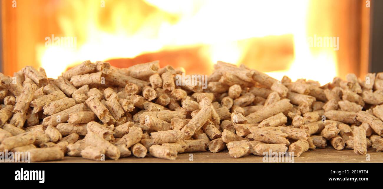 Wood pellets with fire in the background Stock Photo - Alamy