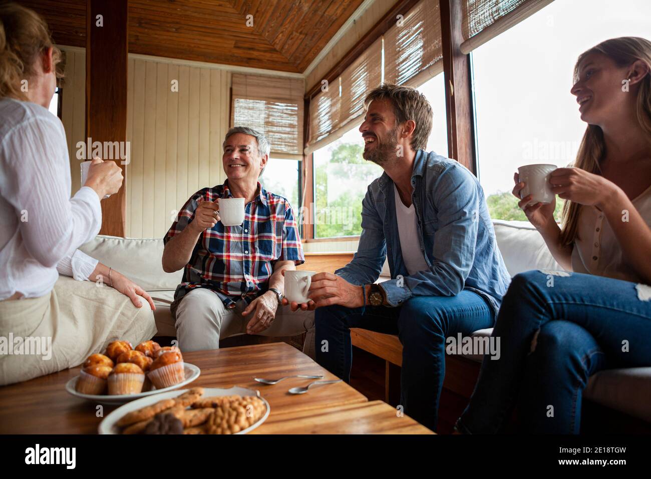 Happy family having coffee at home Stock Photo - Alamy