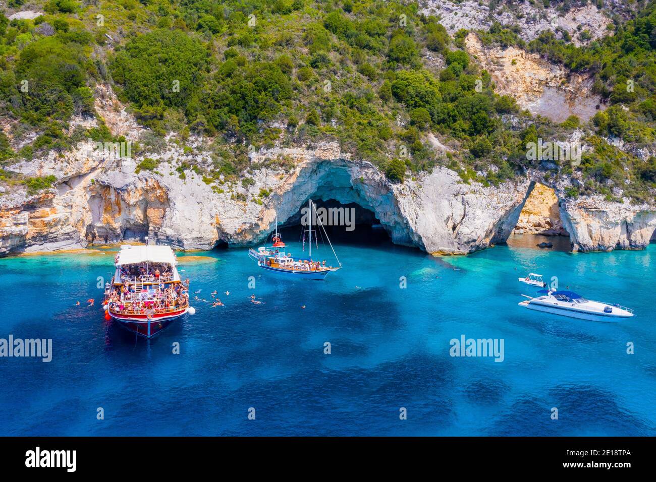 Daily excursion boat with tourists, in secluded beach in Paxoi island ...
