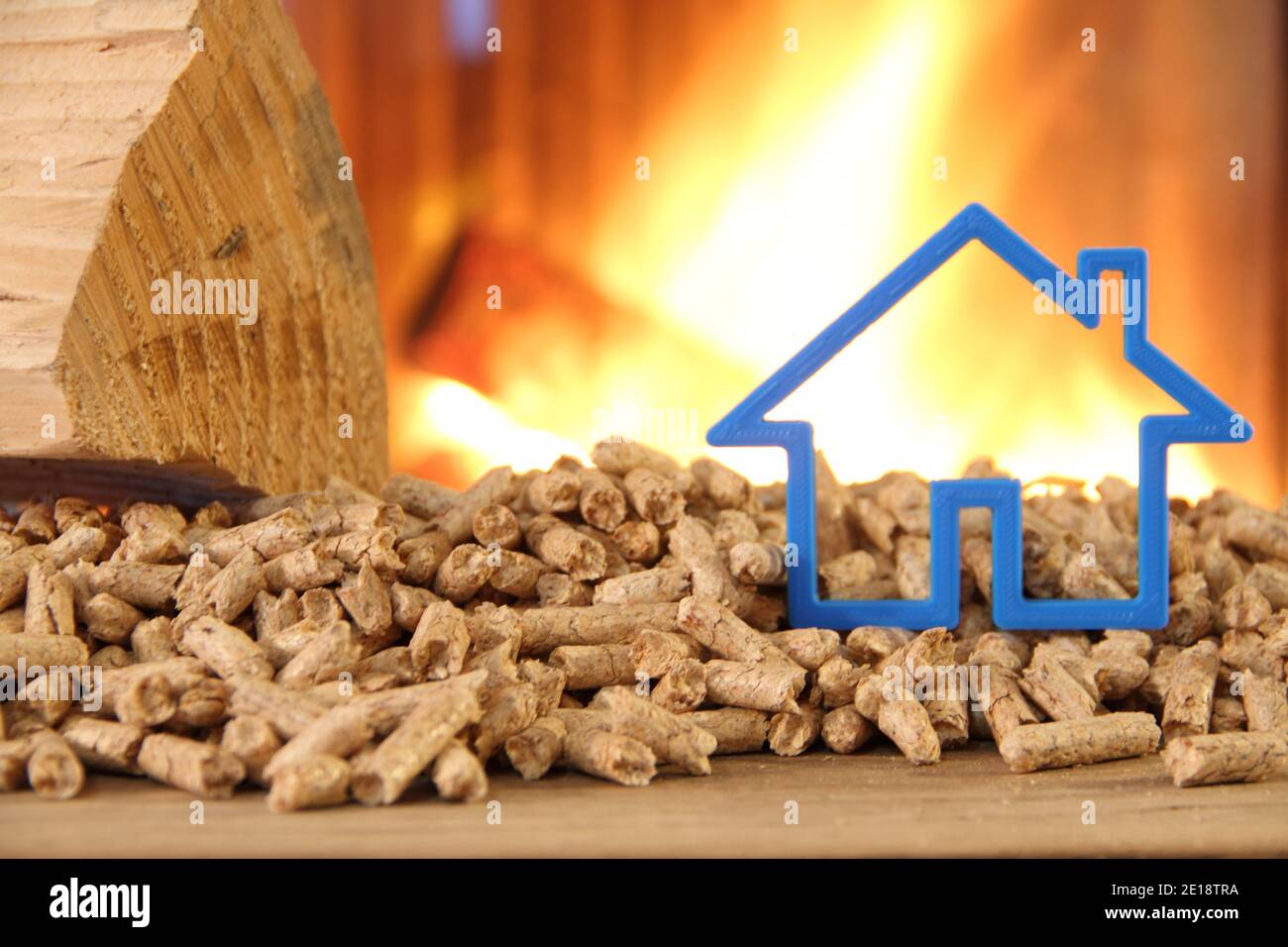 a fireplace with pellets and a small house Stock Photo - Alamy