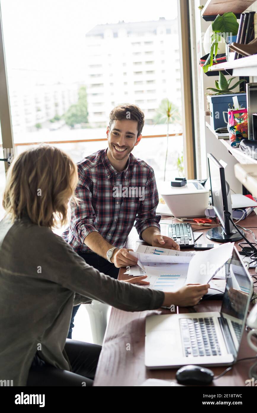 Business people reviewing documents in office Stock Photo - Alamy