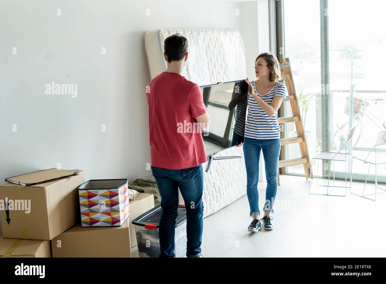 Young couple setting up in their new home Stock Photo - Alamy