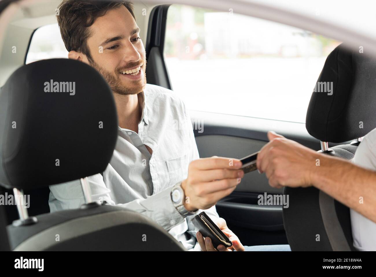 Young man making payment through credit card Stock Photo - Alamy