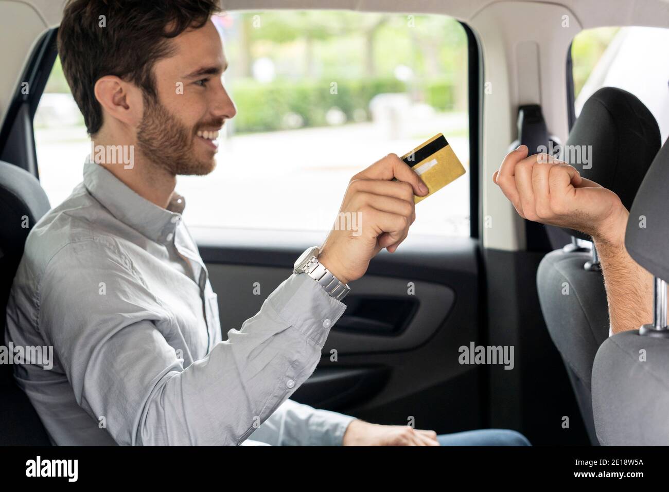 Young man making payment through credit card Stock Photo - Alamy