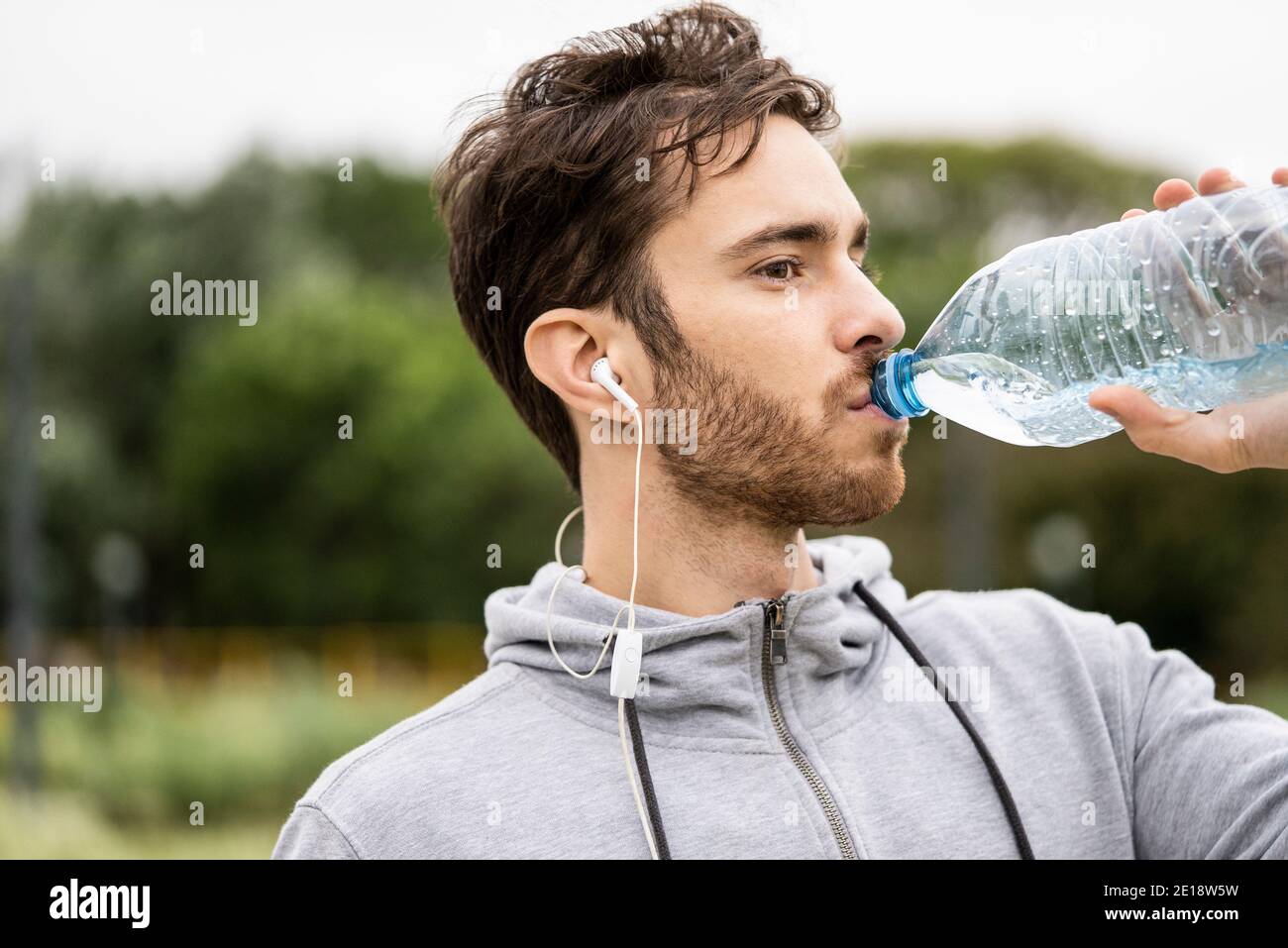 Young man drinking water Stock Photo - Alamy