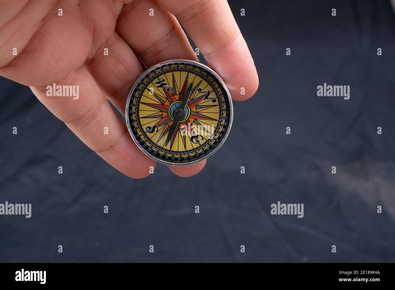 Compass tool in hand o as travel concept Stock Photo - Alamy