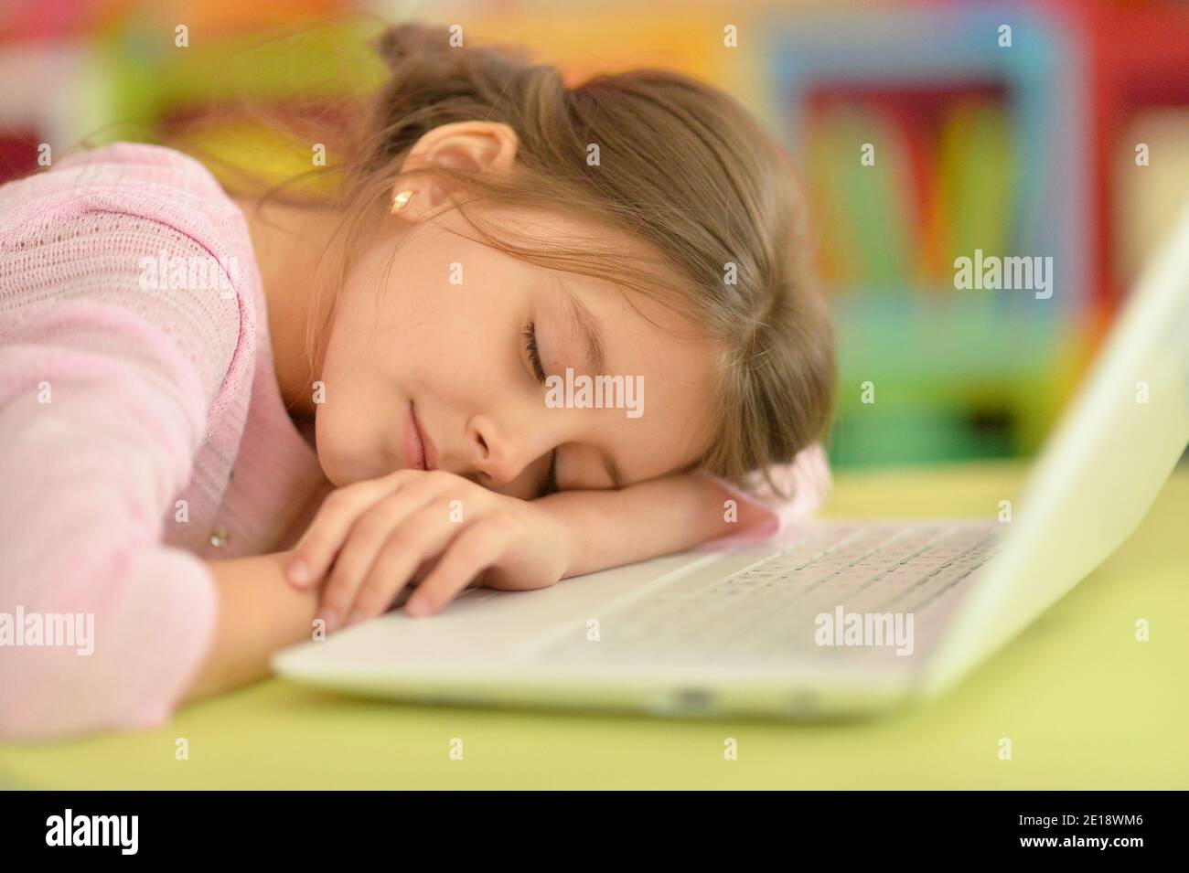 Portrait of cute girl sleeping on laptop at home Stock Photo - Alamy