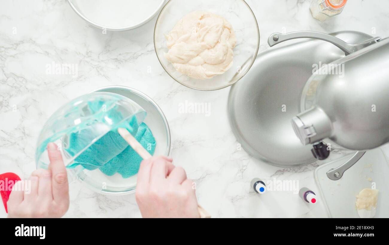 Step by step. Flat lay. Mixing food coloring into a cake batter to bake ...