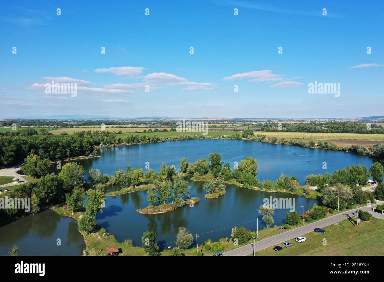 Aerial view of a natural swimming pool in the town of Surany in ...