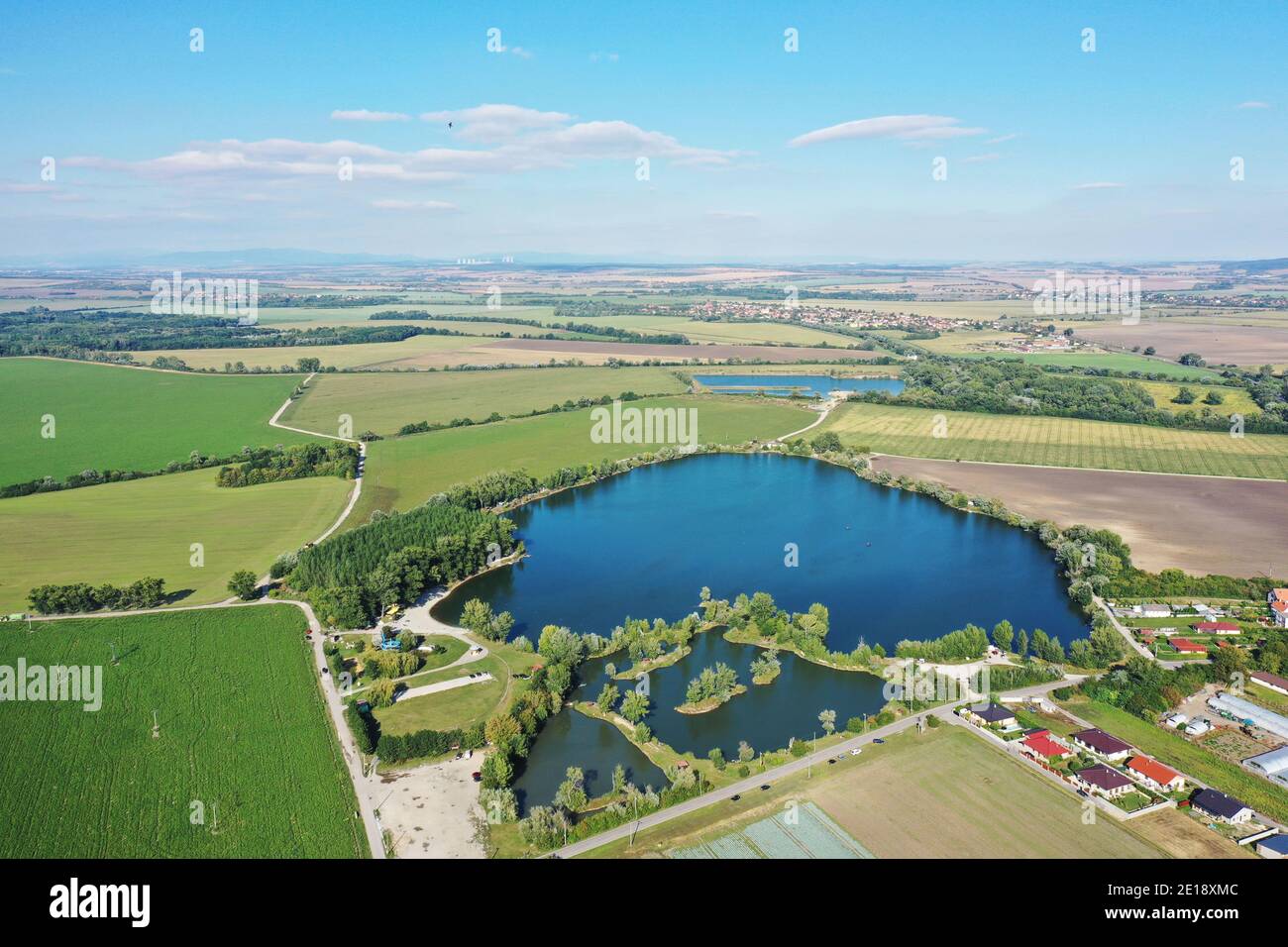 Aerial view of a natural swimming pool in the town of Surany in ...