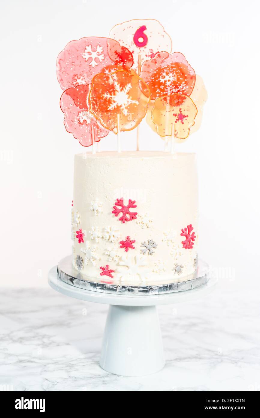 Tall round cake with Italian buttercream frosting decorated with ...