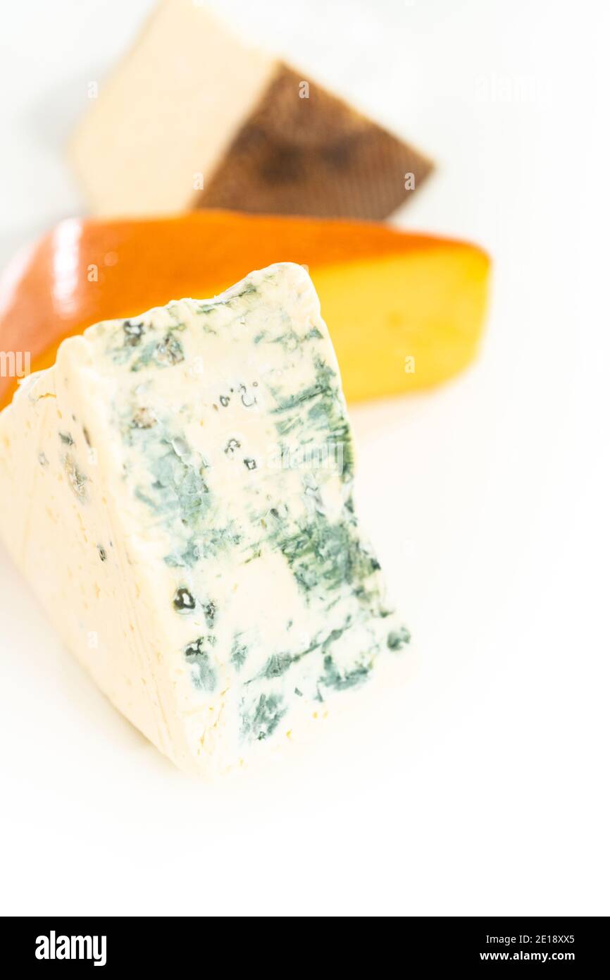 Variety of large wedges gourmet cheese on a white background Stock ...