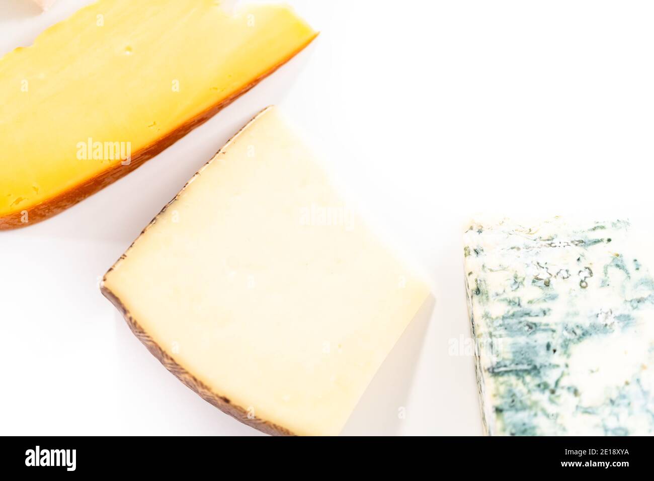 Variety of large wedges gourmet cheese on a white background Stock ...