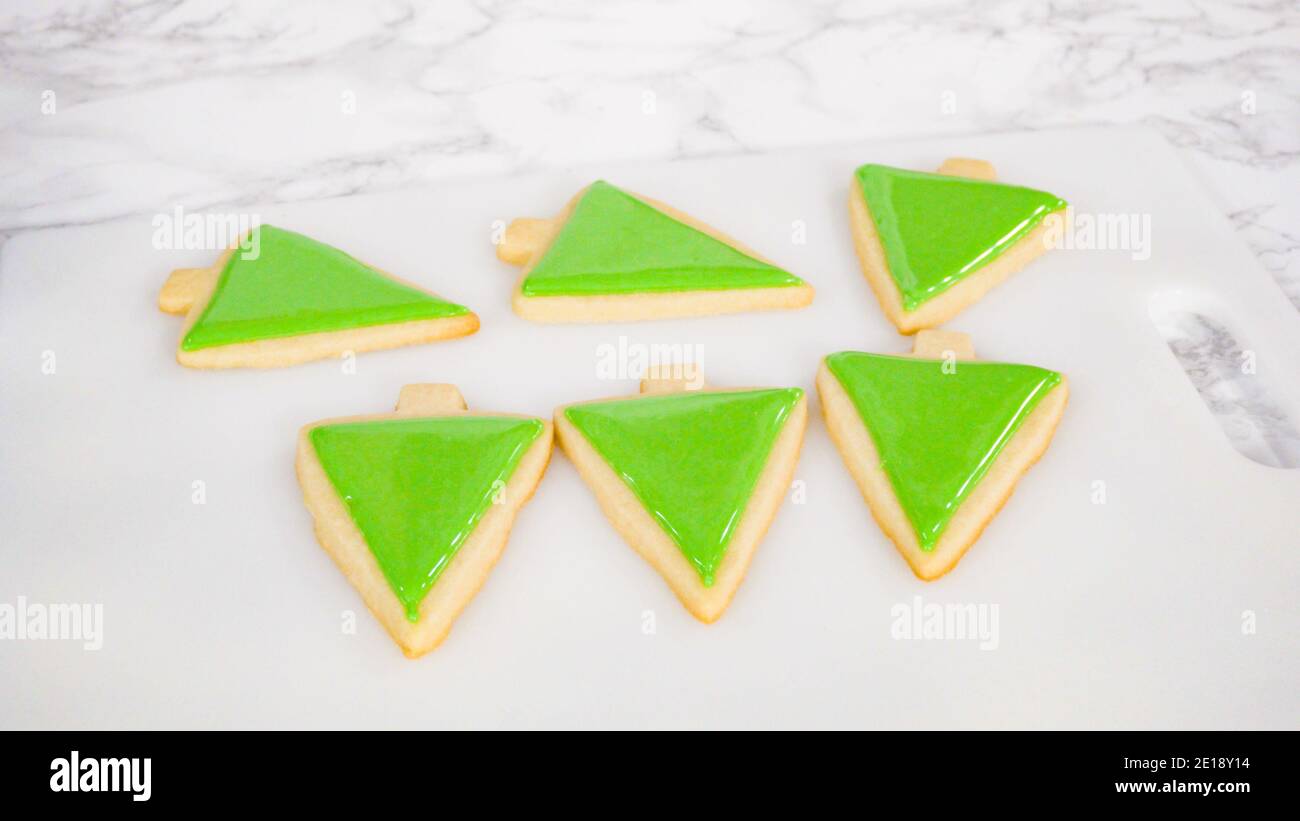 Stp by step. Icing Christmas tree-shaped sugar cookies with green royal ...