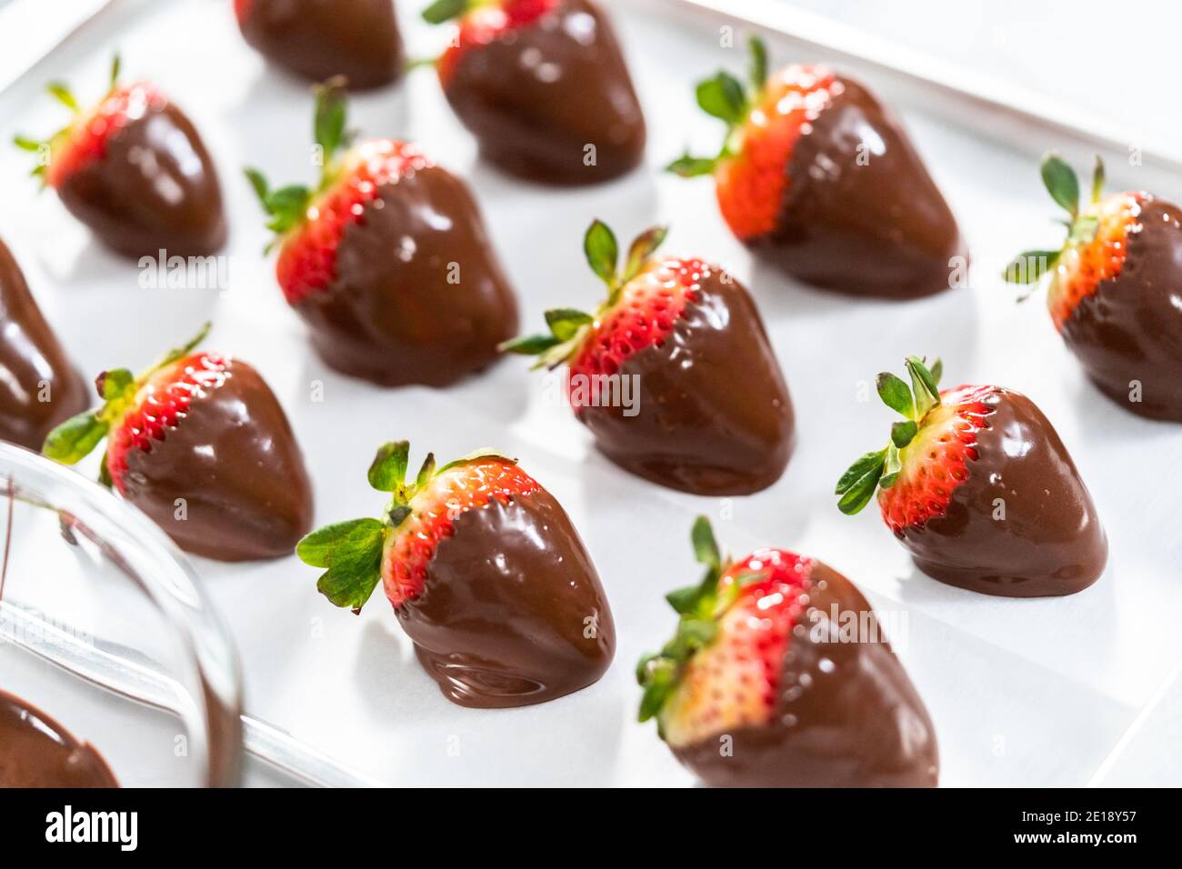 Making white and dark chocolate dipped strawberries Stock Photo - Alamy