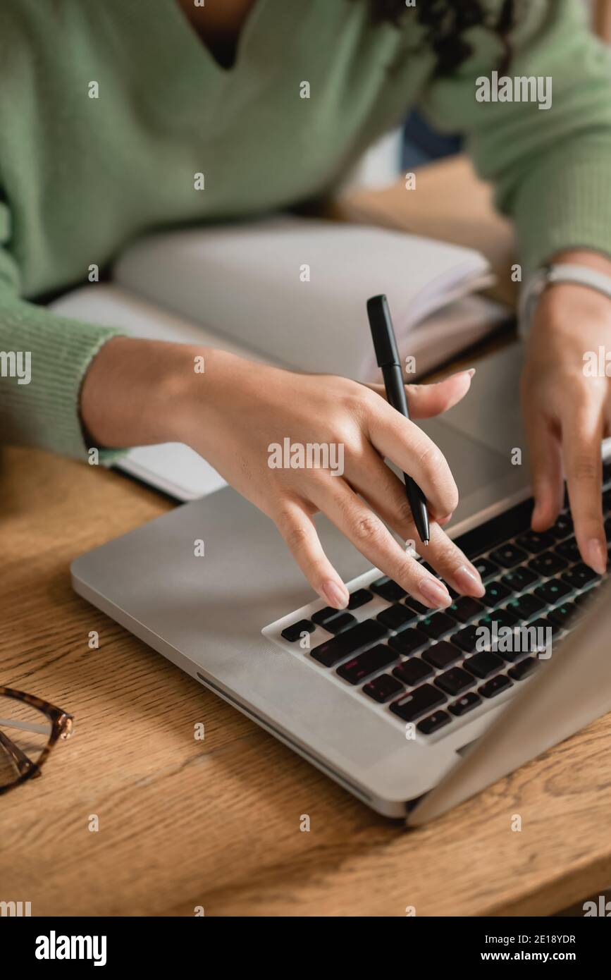 Crop woman holding laptop typing hi-res stock photography and images ...