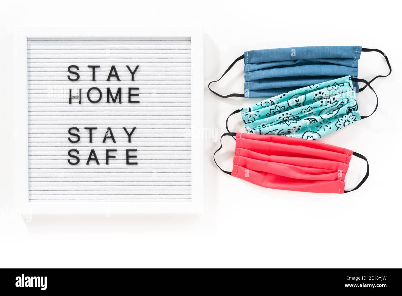 STAY HOME and STAY SAFE sign on message board with a homemade face mask ...