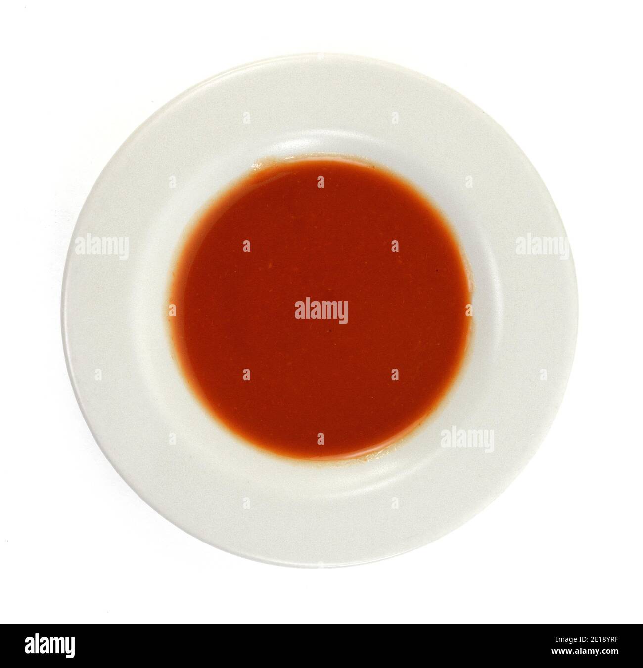 Closeup red ketchup tomato soup in a plate isolated on white background ...