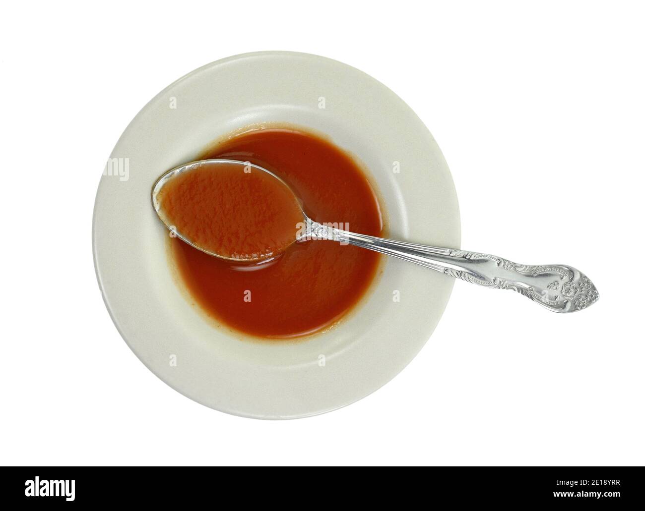 Closeup red ketchup tomato soup in a plate isolated on white background ...
