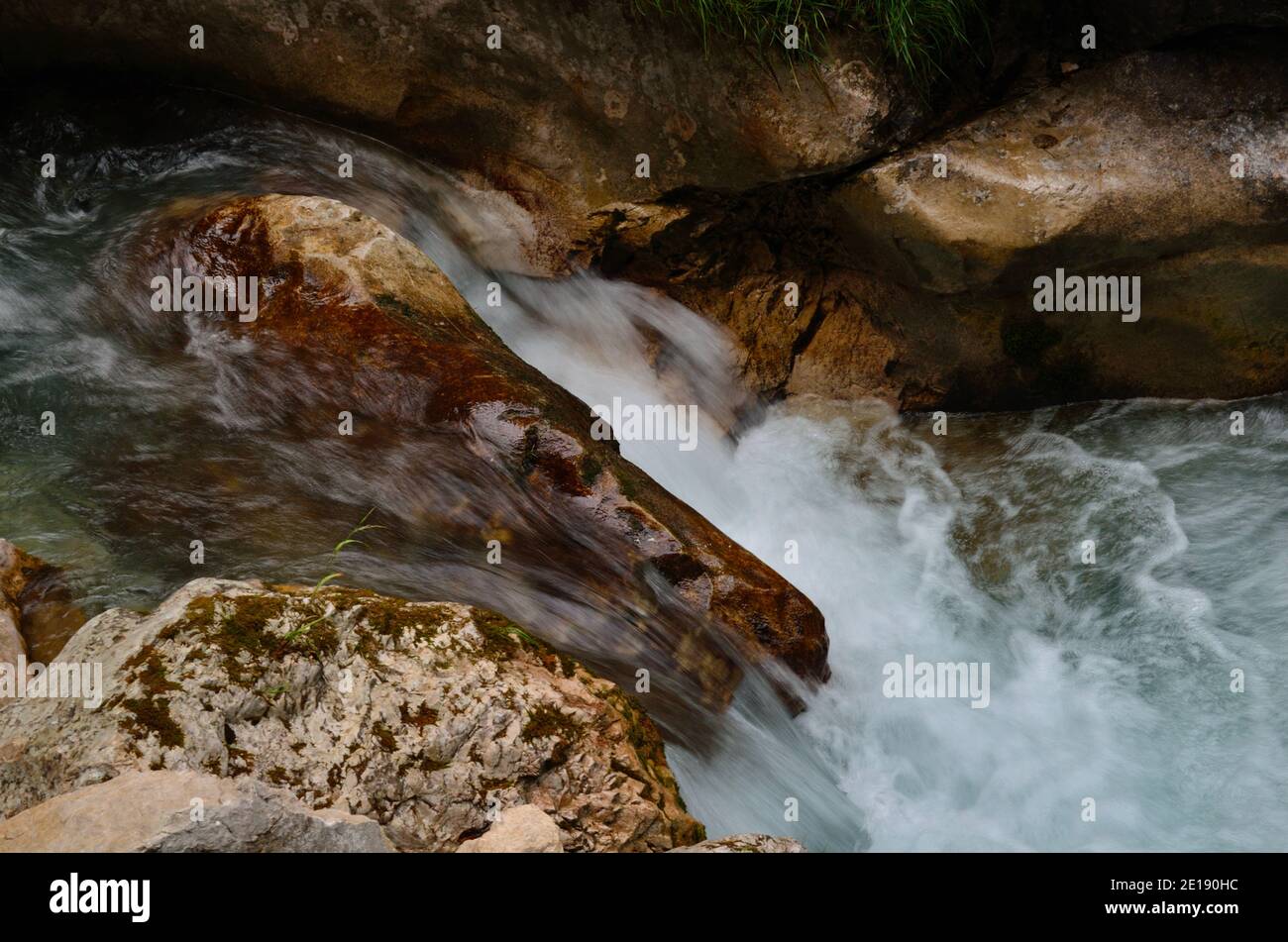 clear wild water between rocks in the mountains Stock Photo - Alamy