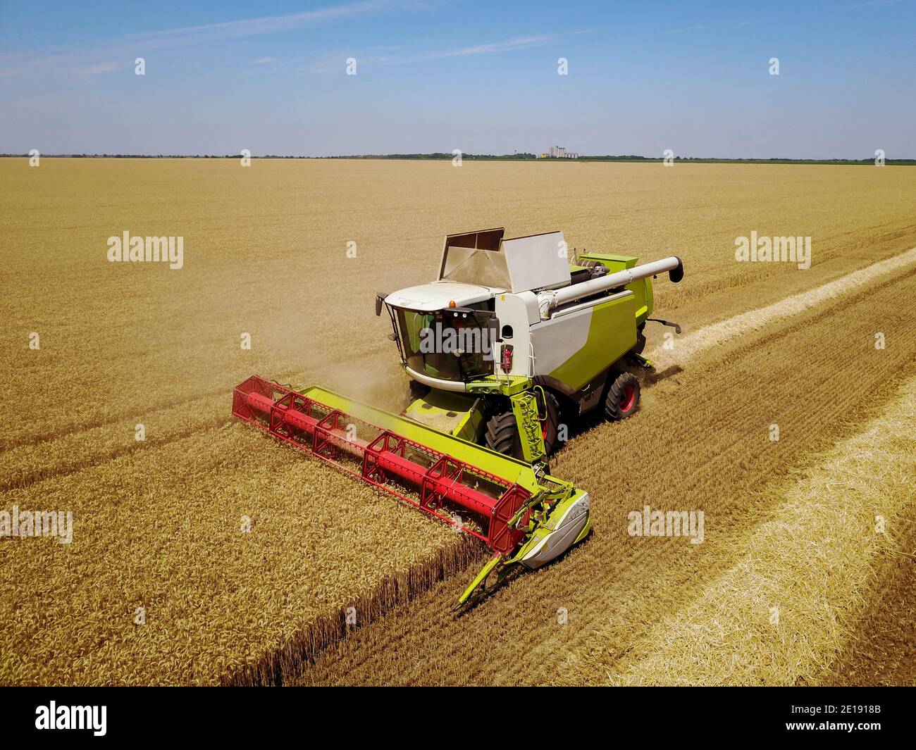 Large professional combine harvester working in the wheat field Stock ...