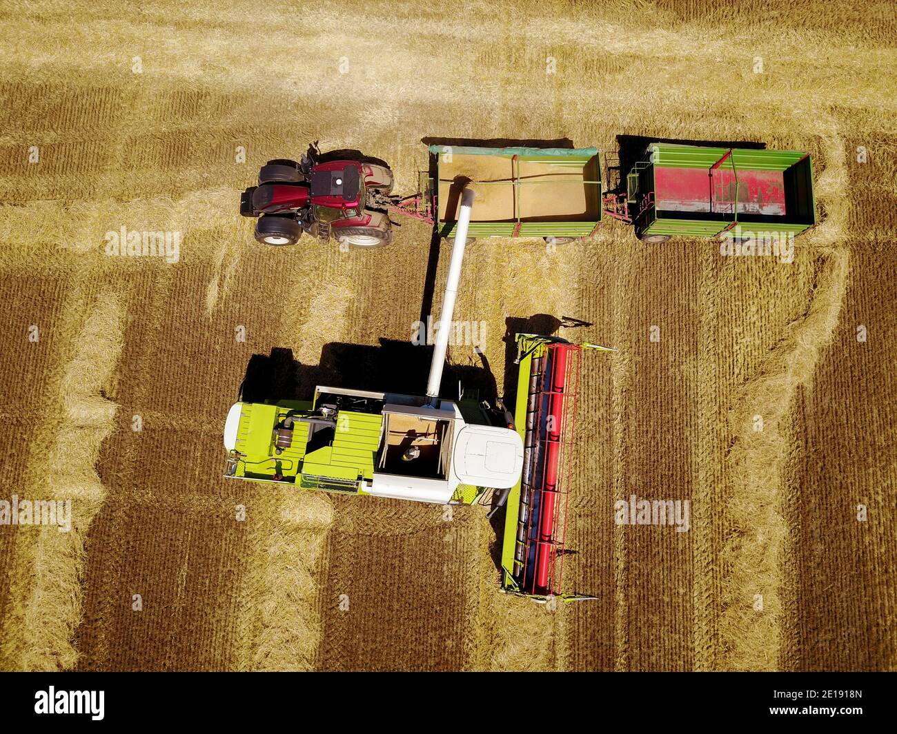 Aerial view of professional combine harvester machine overloading ...