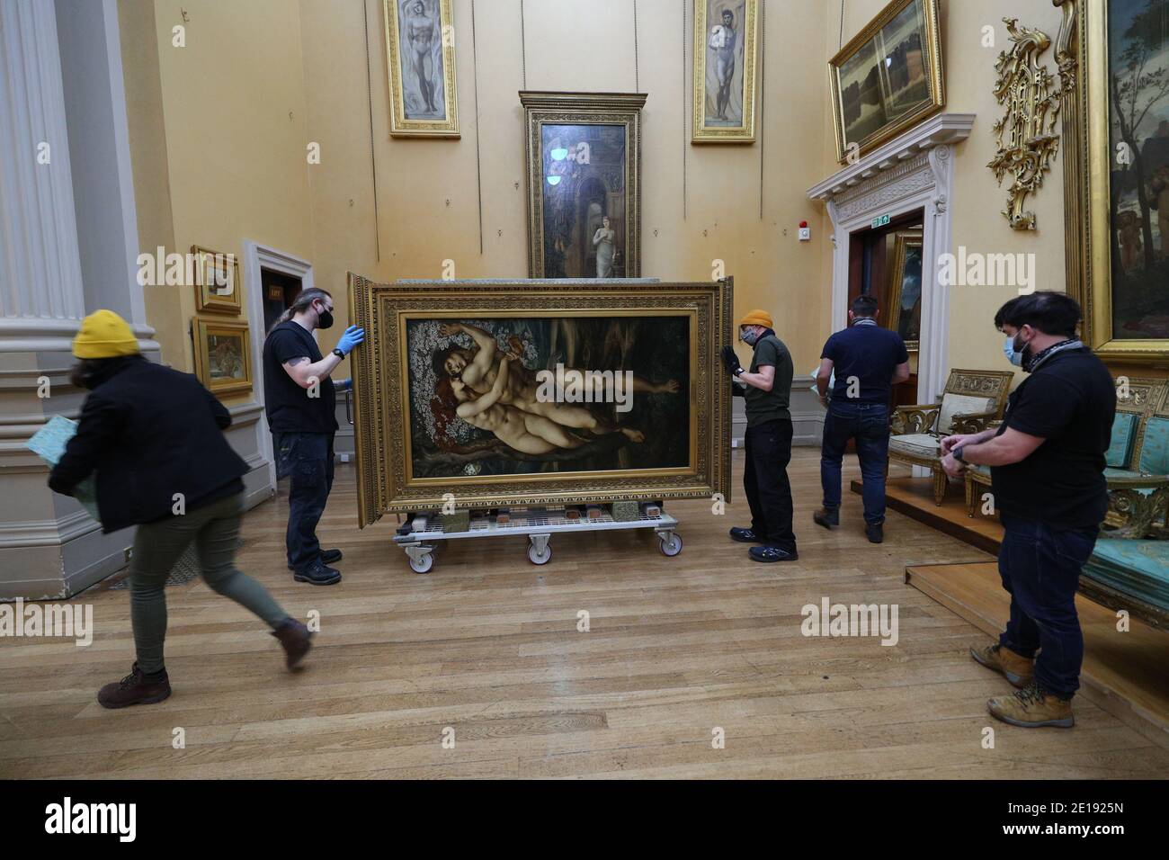 The Beguiling of Merlin by Edward Burne-Jones is prepared for hanging ...