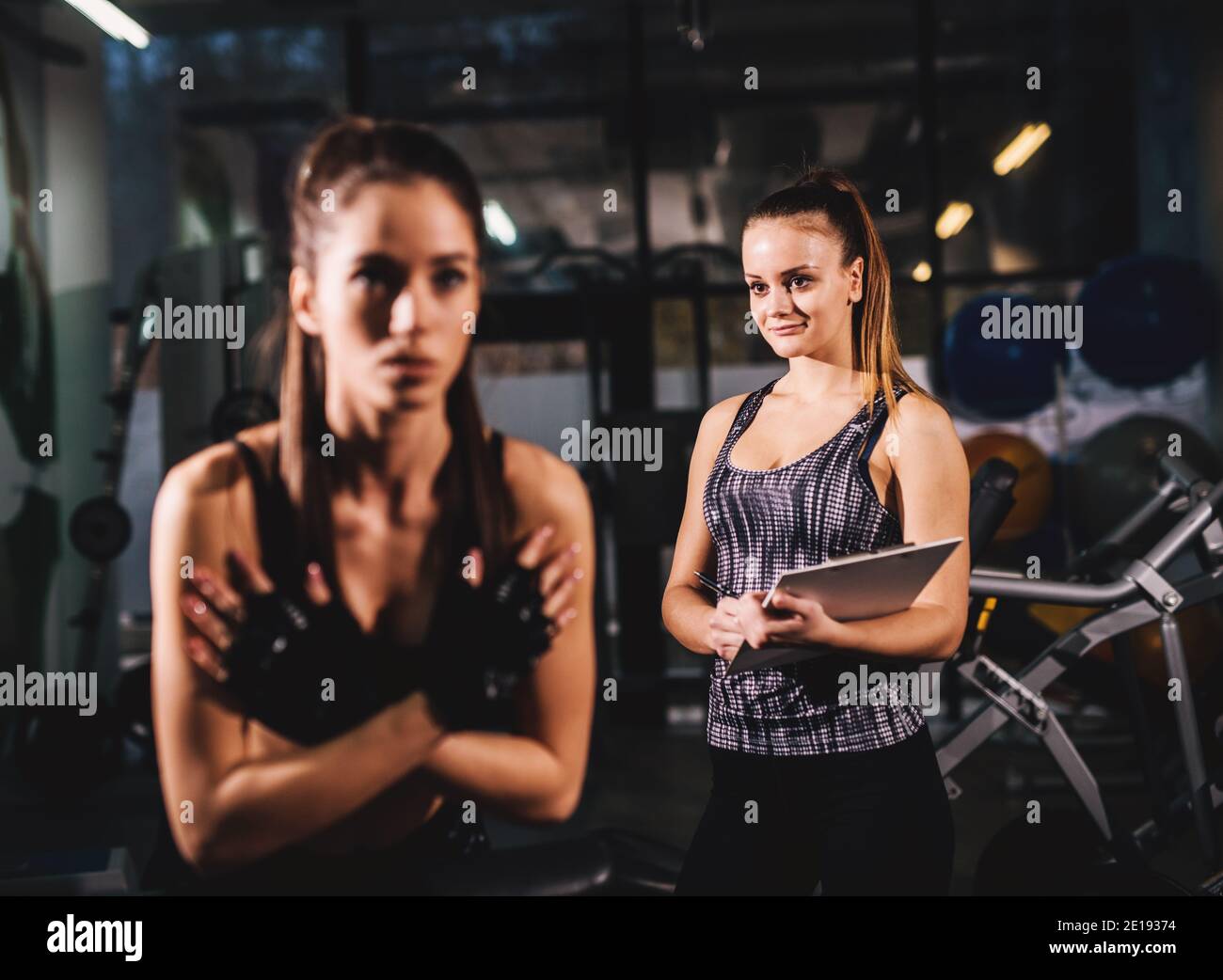 Picture of personal trainer holding a clipboard and checking the ...