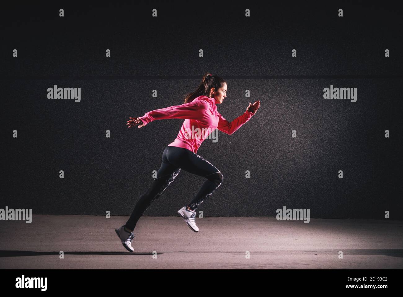 Side motion view of attractive sporty athlete running girl in ...
