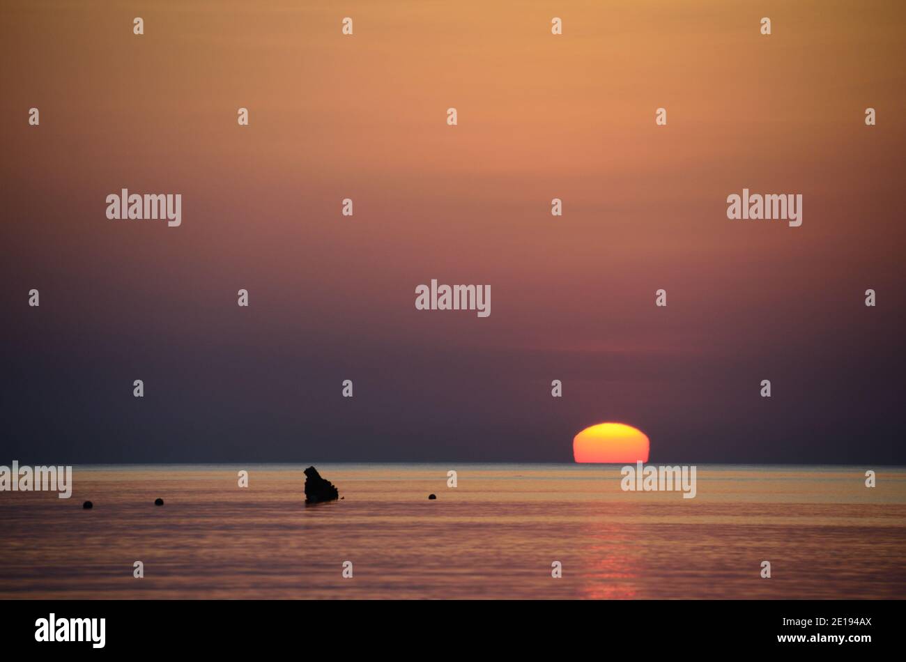 warm sunrise on the horizon and the sea on vacation Stock Photo - Alamy