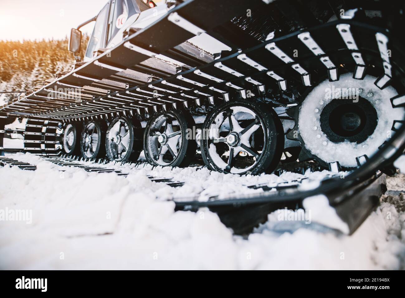 Close up view of special snow vehicle with the caterpillar on the snow ...