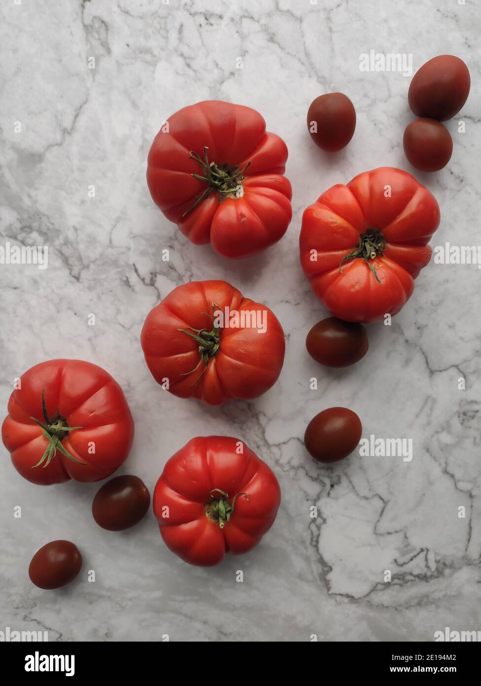 Red vegetables in a white marble table Stock Photo - Alamy
