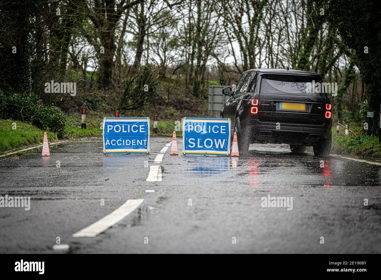 car driving past Police Acident signs on a wet road Stock Photo - Alamy