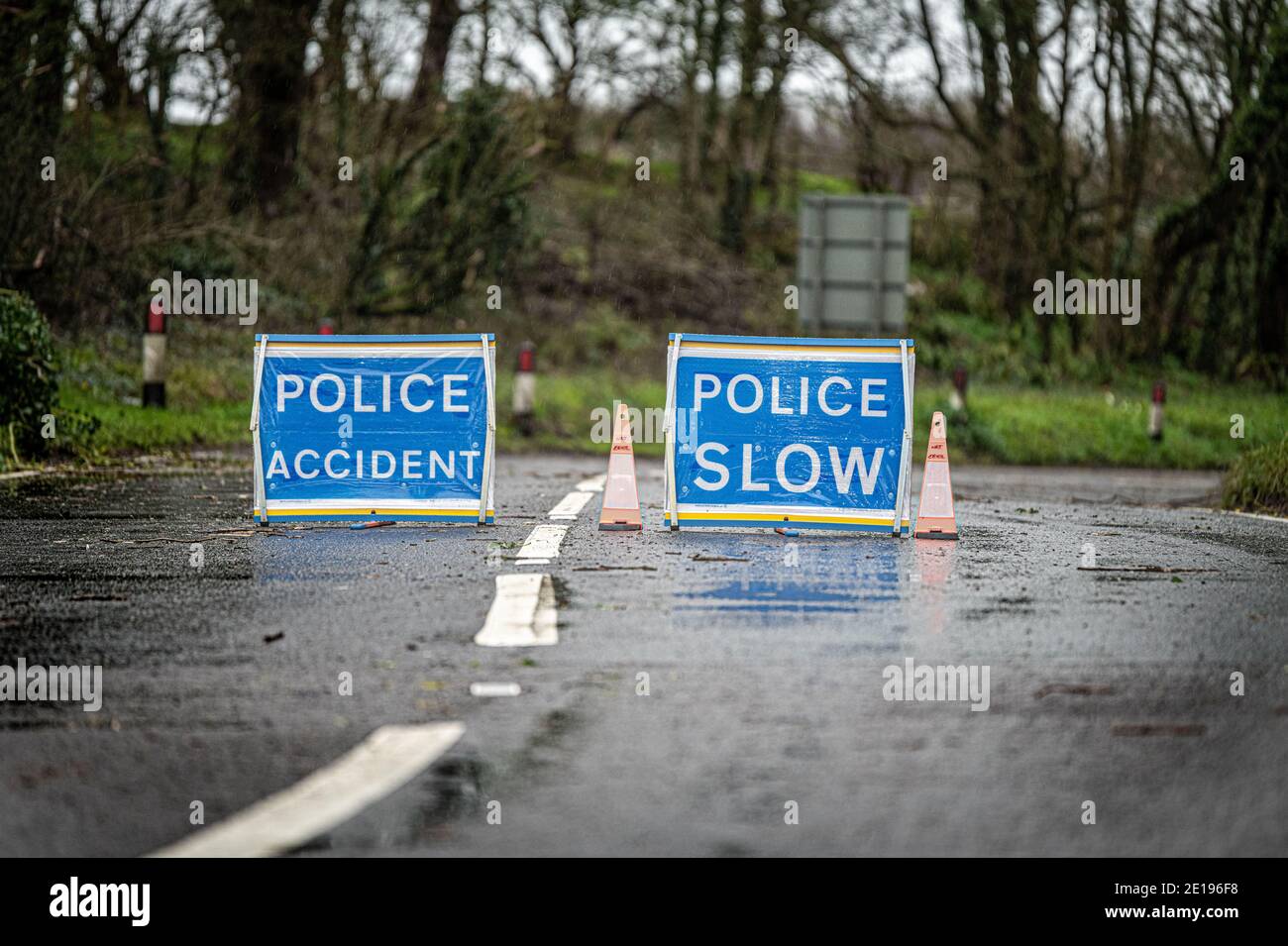 Police slow signs on wet road hi-res stock photography and images - Alamy