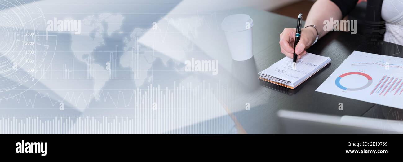Businesswoman analyzing marketing data and taking notes; panoramic ...