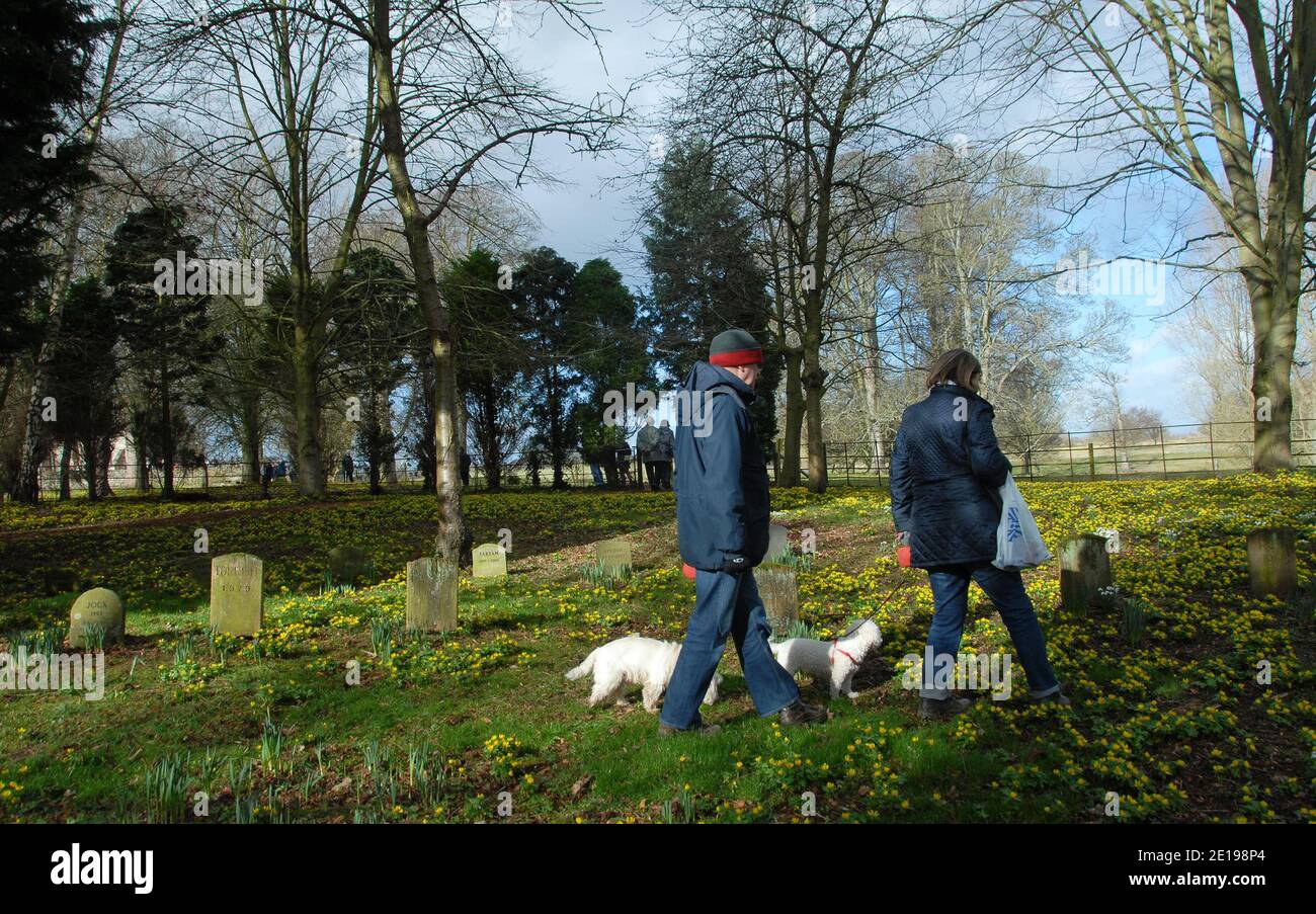 Dog walkers pause in the dog cemetery in Little Ponton Hall gardens ...