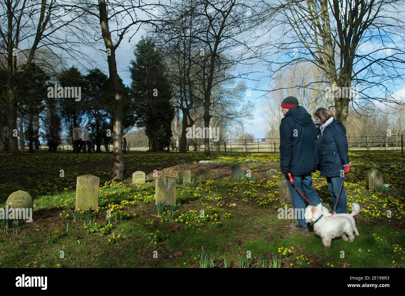 Dog walkers pause in the dog cemetery in Little Ponton Hall gardens ...
