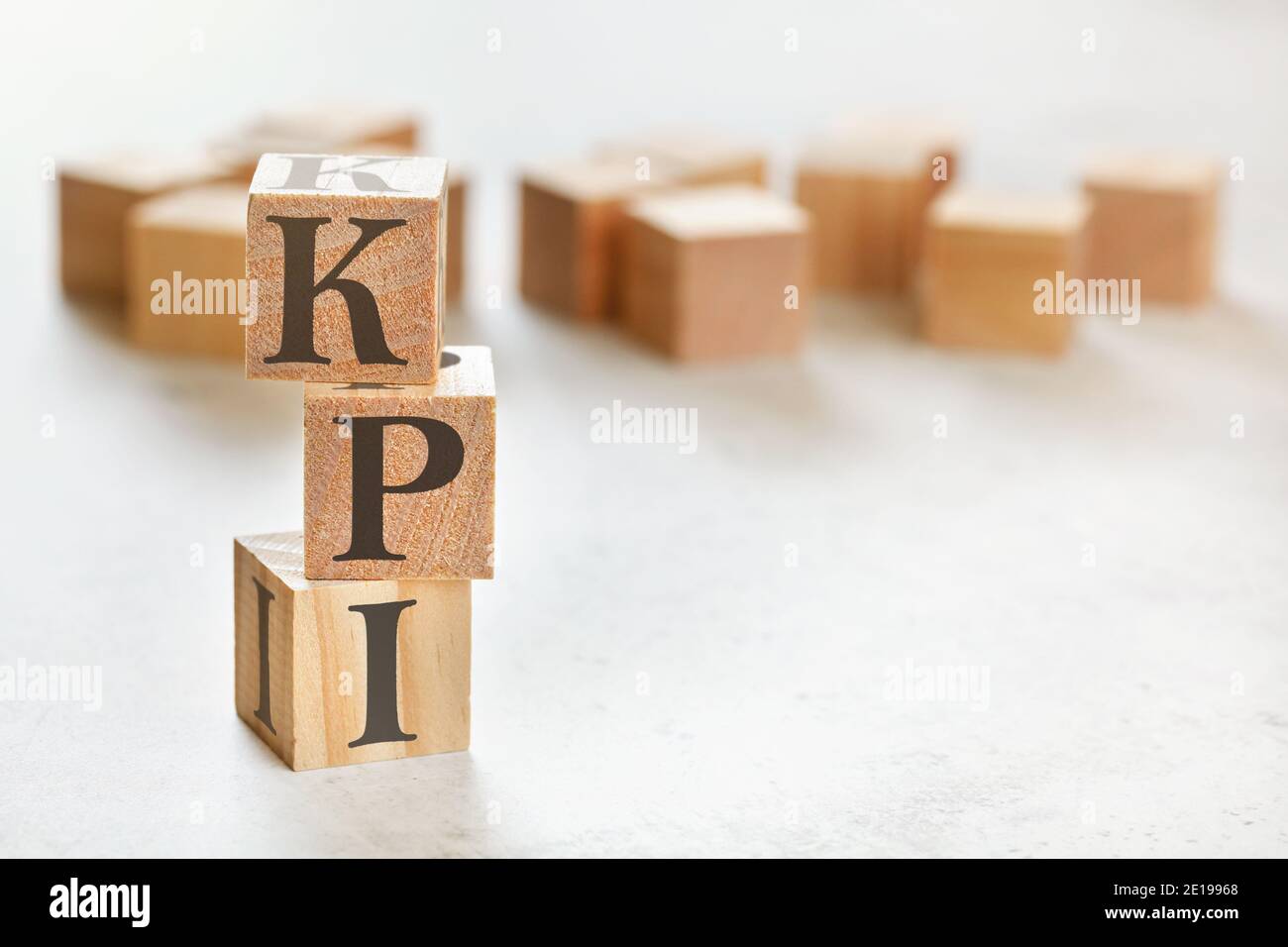 Three wooden cubes with letters KPI (means Key Performance Indicator ...