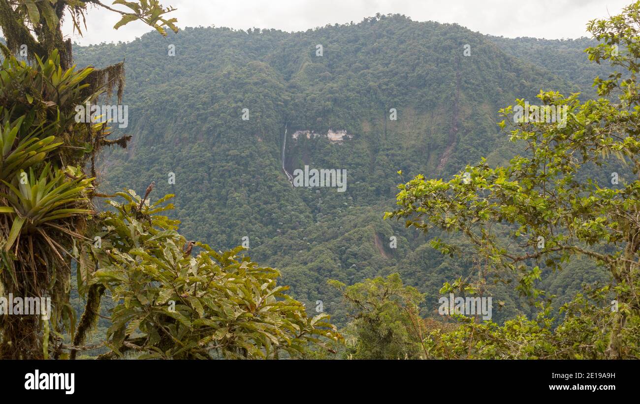 Steep cliff with waterfall and limestone outcrop in the Quijos Valley ...