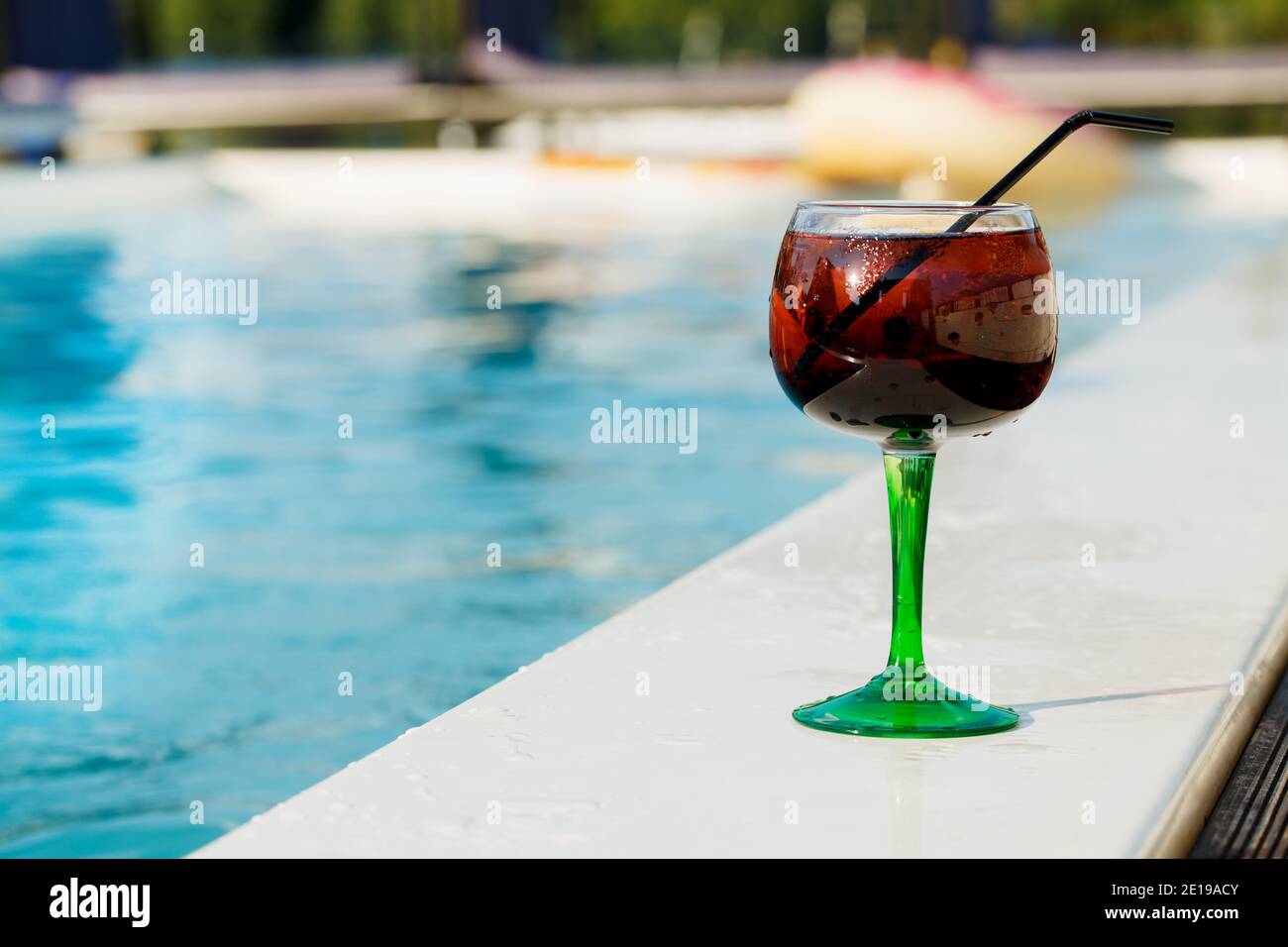 Delicious refreshing cocktail near the swimming pool on a hot summer ...