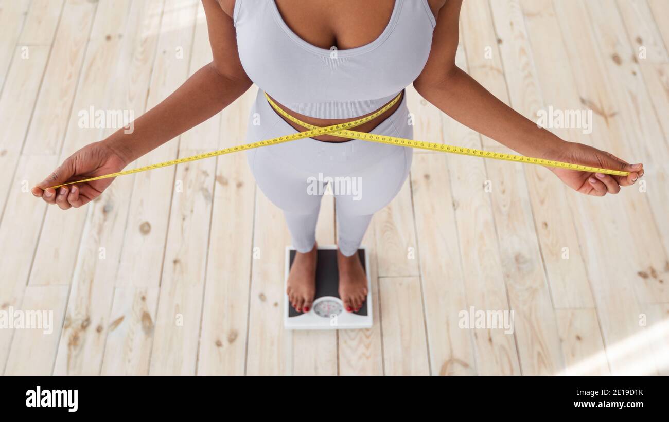 Fat person on scales hi-res stock photography and images - Alamy