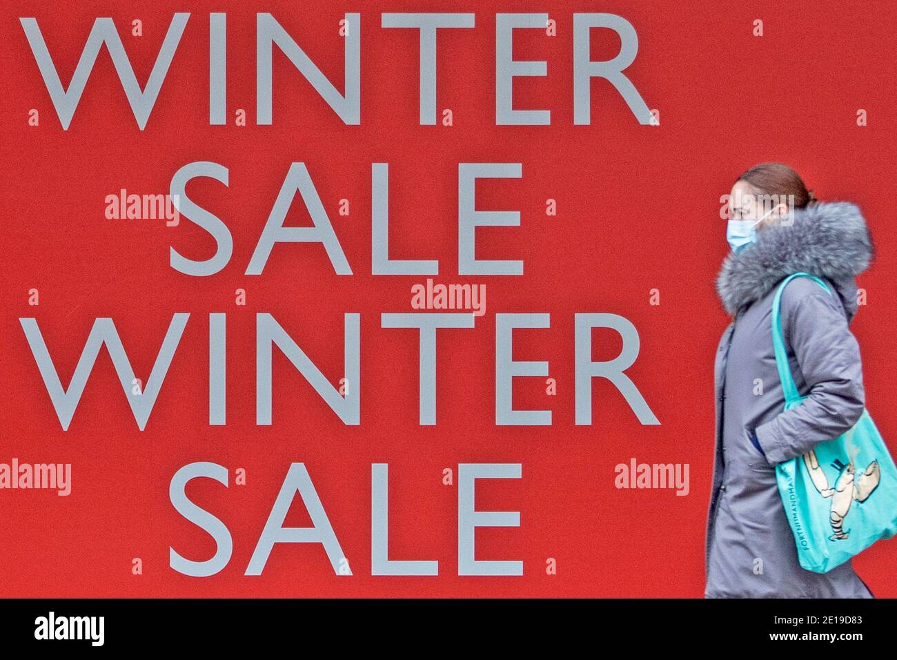 Winter Sale sign with people in masks on Oxford Street during the ...