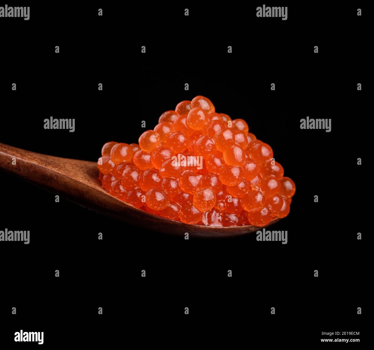 fresh grainy red chum salmon caviar in a wooden spoon, delicious and ...