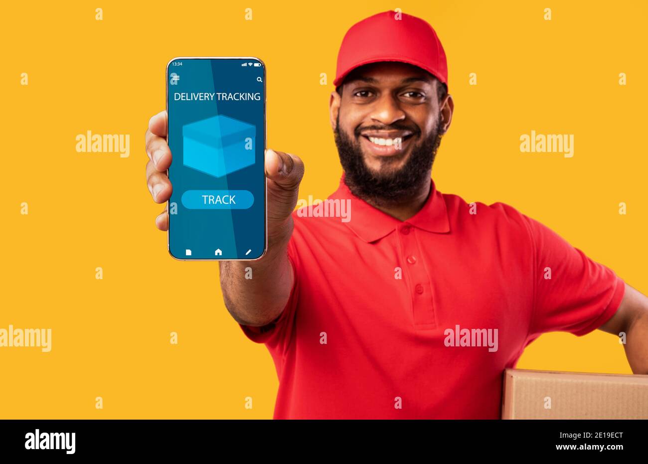 Black man holding smartphone with delivery tracking app Stock Photo - Alamy