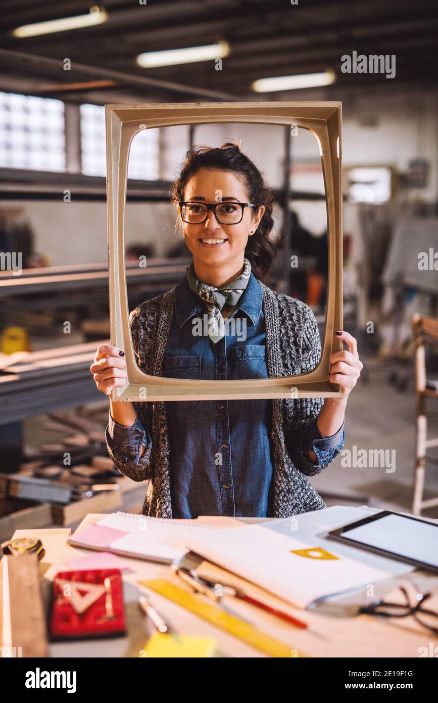 Close up vertical view of cheerful happy middle aged engineer holding ...