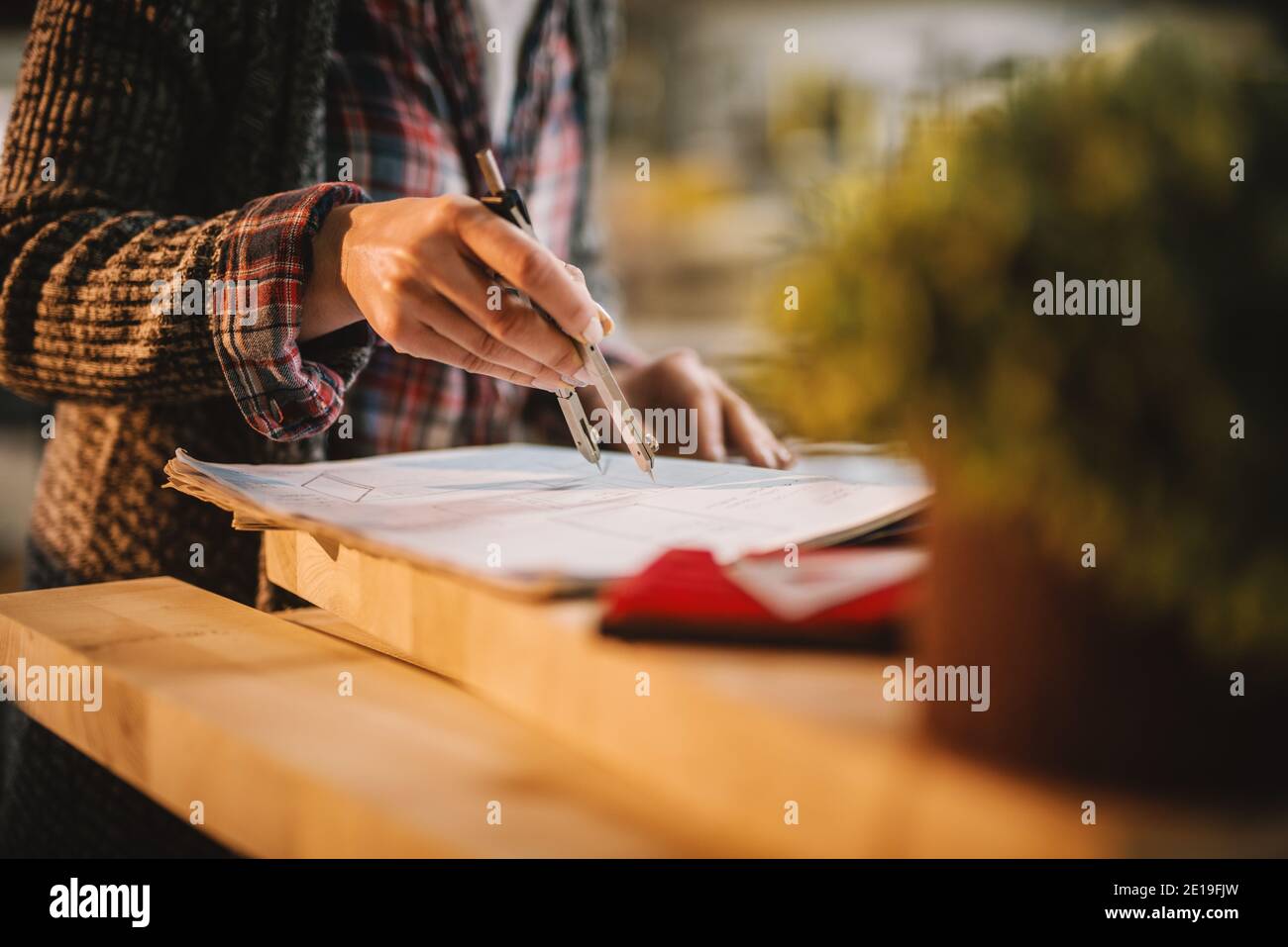 Close up of focused industrial female engineer working with drawing ...