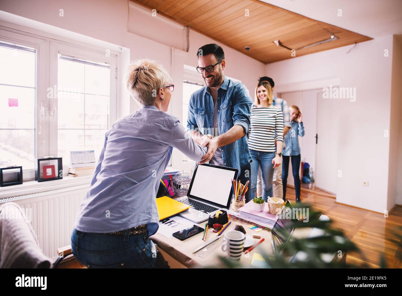 Happy satisfied young man shaking hand with entrepreneur after a ...