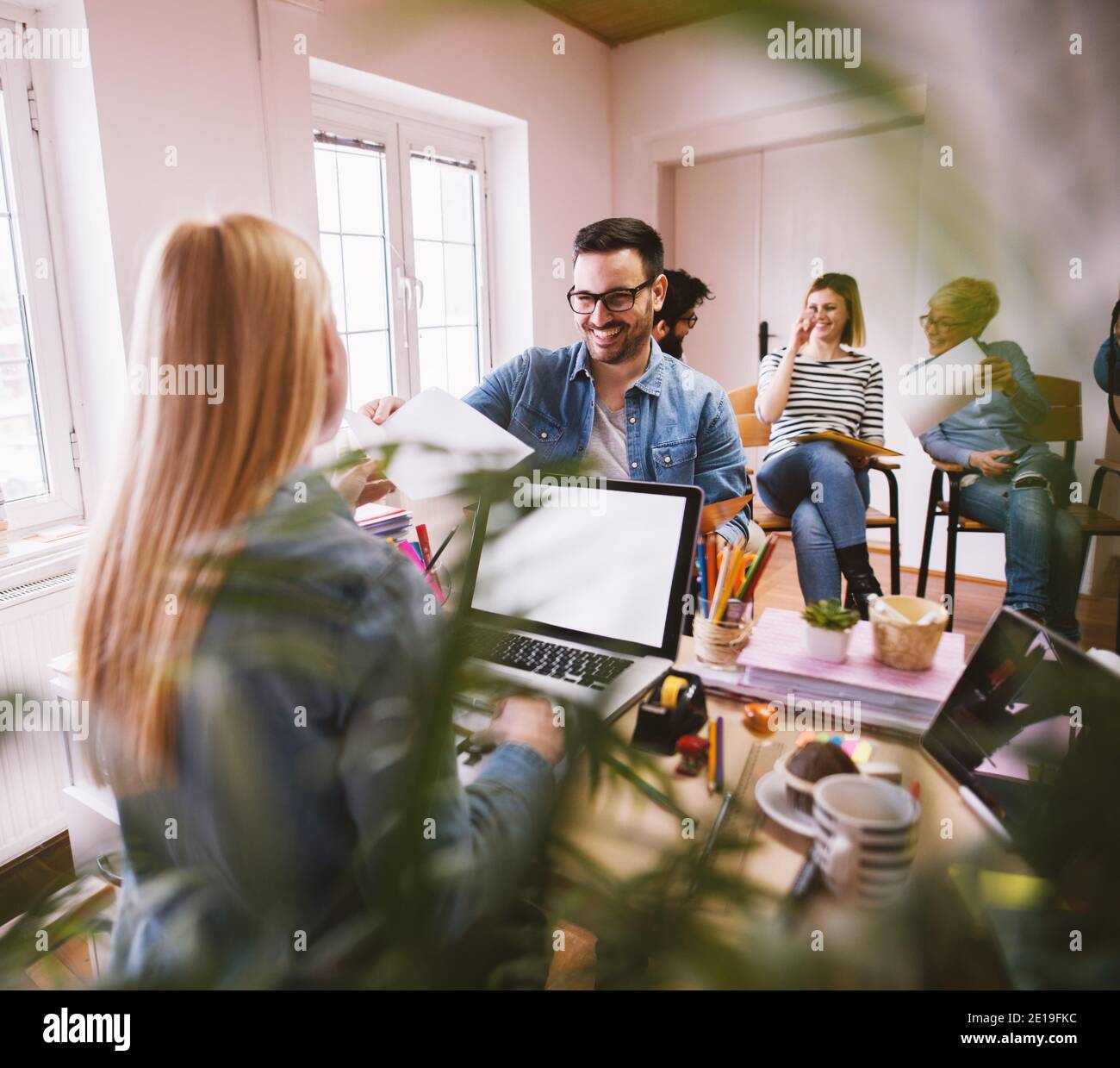 Young confident motivated guy giving his personal portfolio to female ...